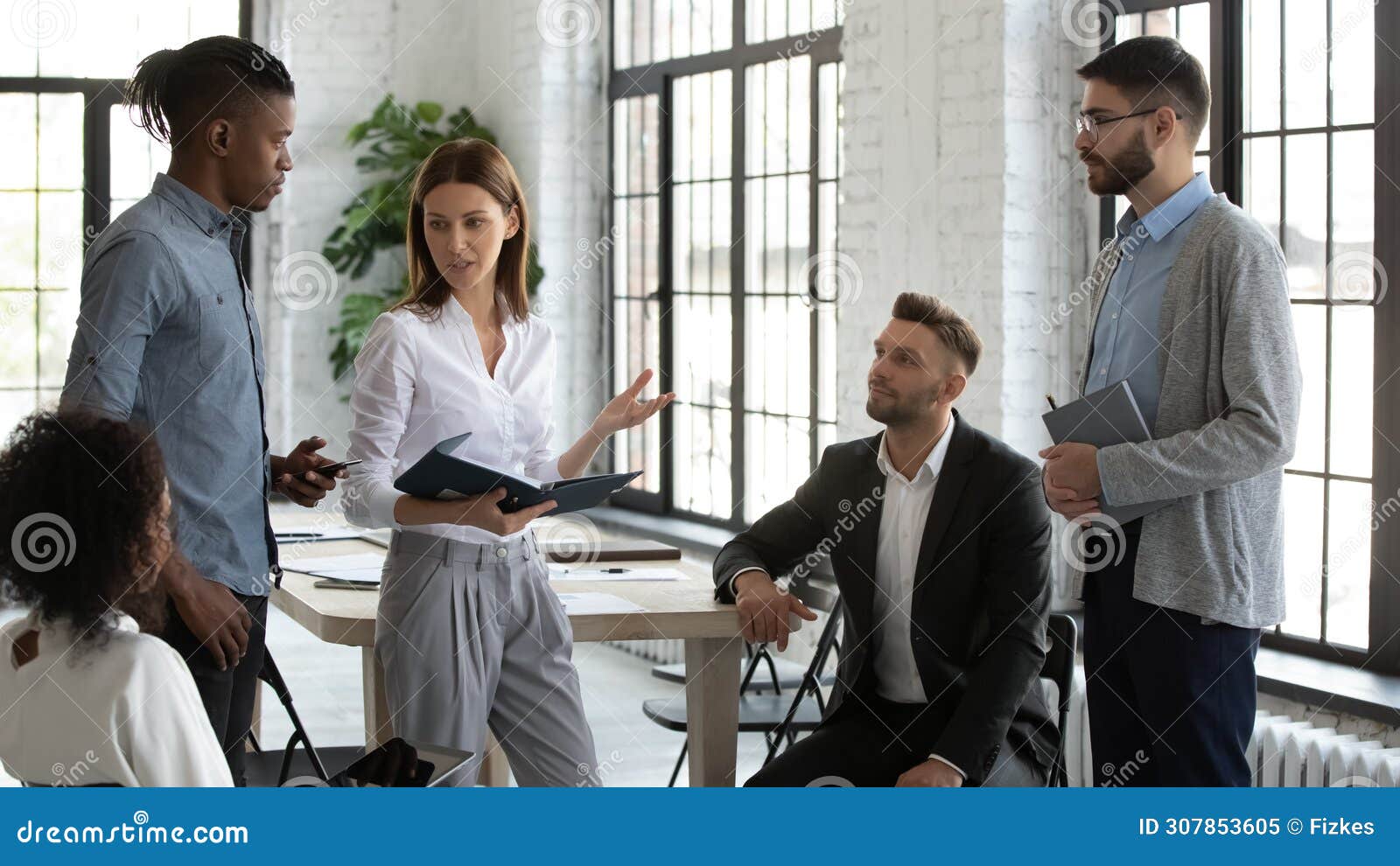 Manager and Employees Going Over Tasks during Briefing Stock Image ...