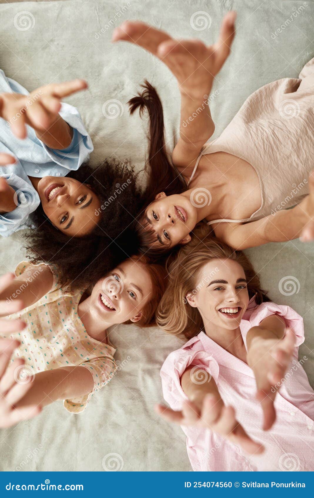 Top of Multiethnic Girls Pulling Hands Up on Bed Stock Photo - Image of ...