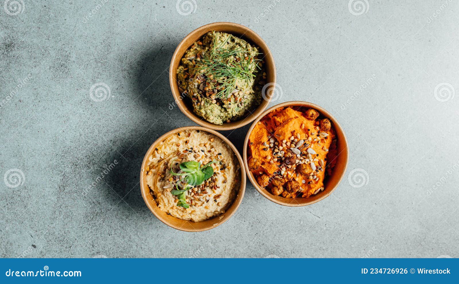 Top Shot of Three Different Hummuses in Wooden Bowls. Stock Photo ...