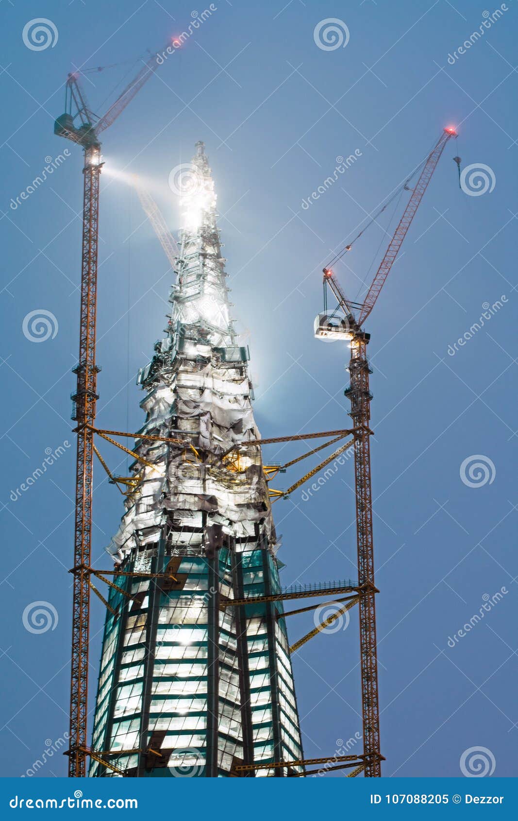 The Top of a Tall Building in the Clouds Illuminated by Construction ...