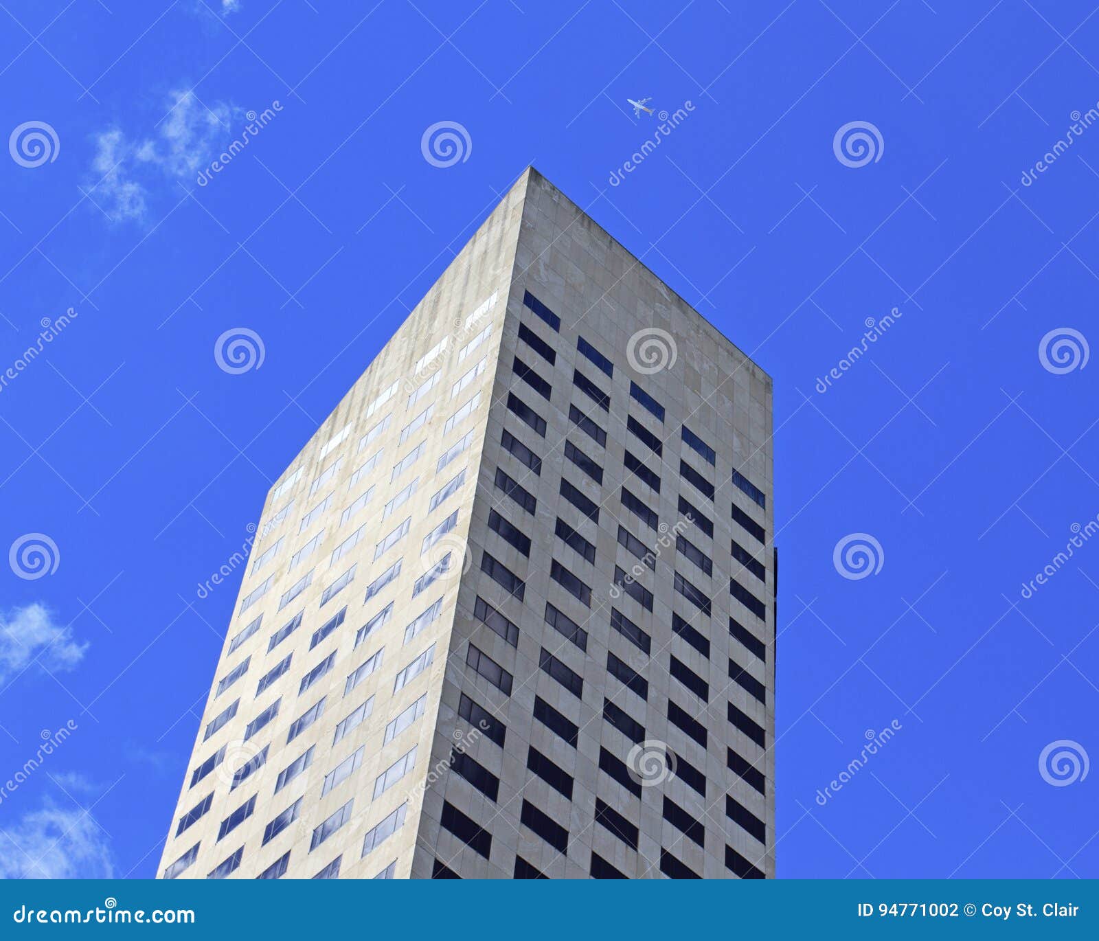 The Top of a Towering Skyscraper in Front of Blue Sky Stock Photo ...