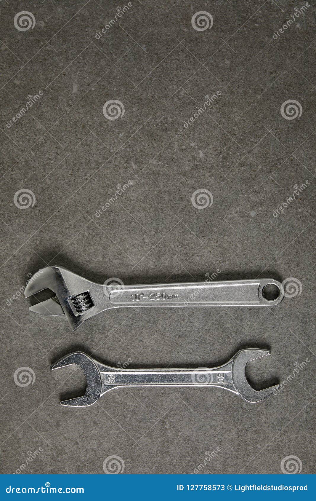 Top View of Adjustable Wrench and Spanner on Gray Surface Stock Image ...