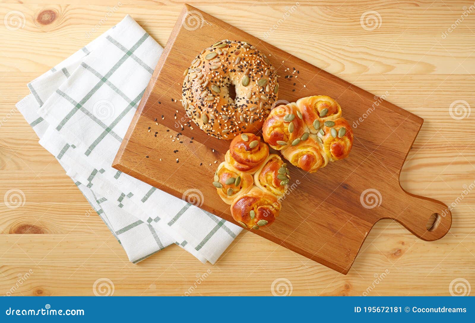 Top View of Assorted Breads on the Wooden Breadboard with Kitchen Cloth ...