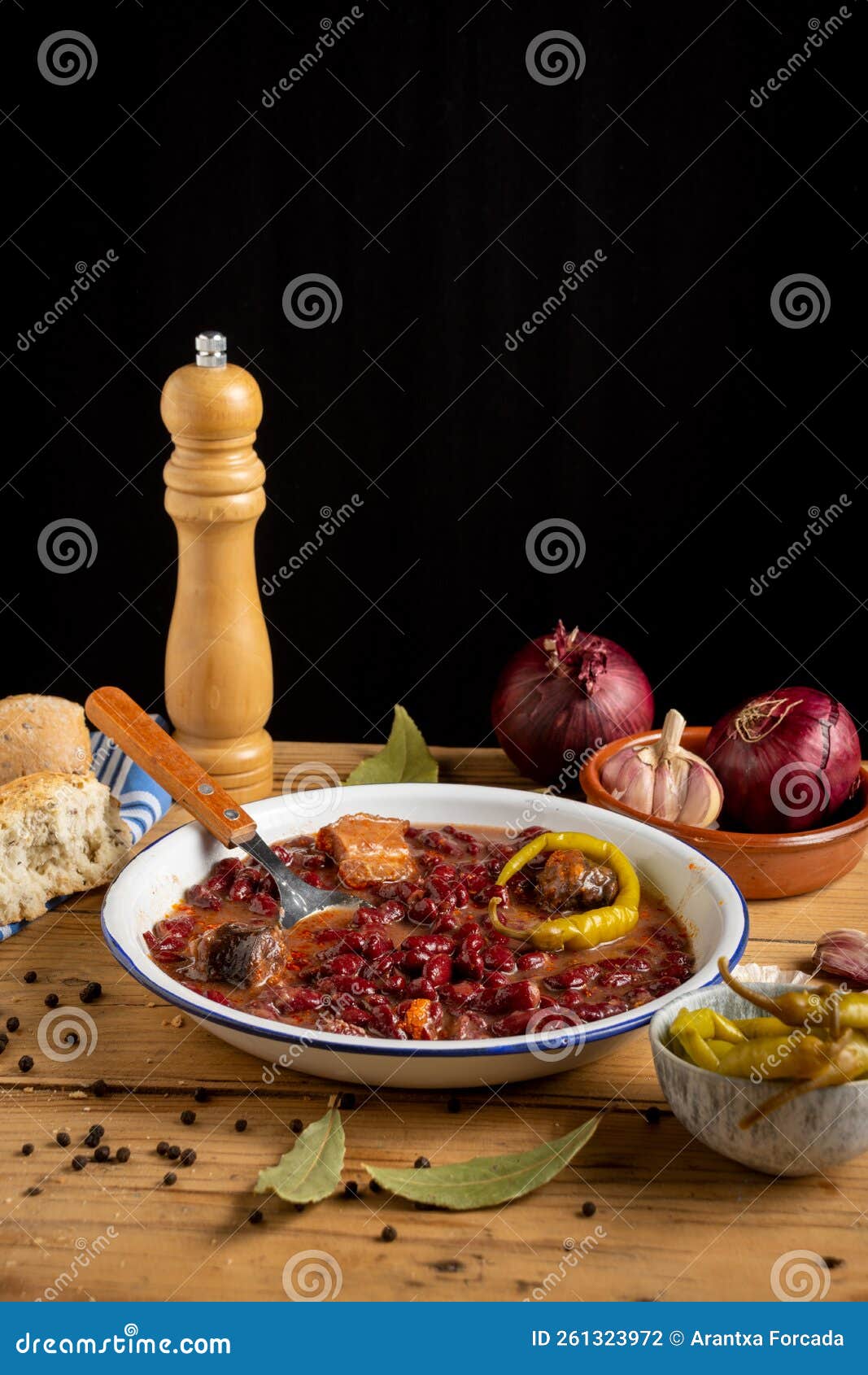 Top View of Basque Bean Stew with Spoon on Rustic Table with Onions ...