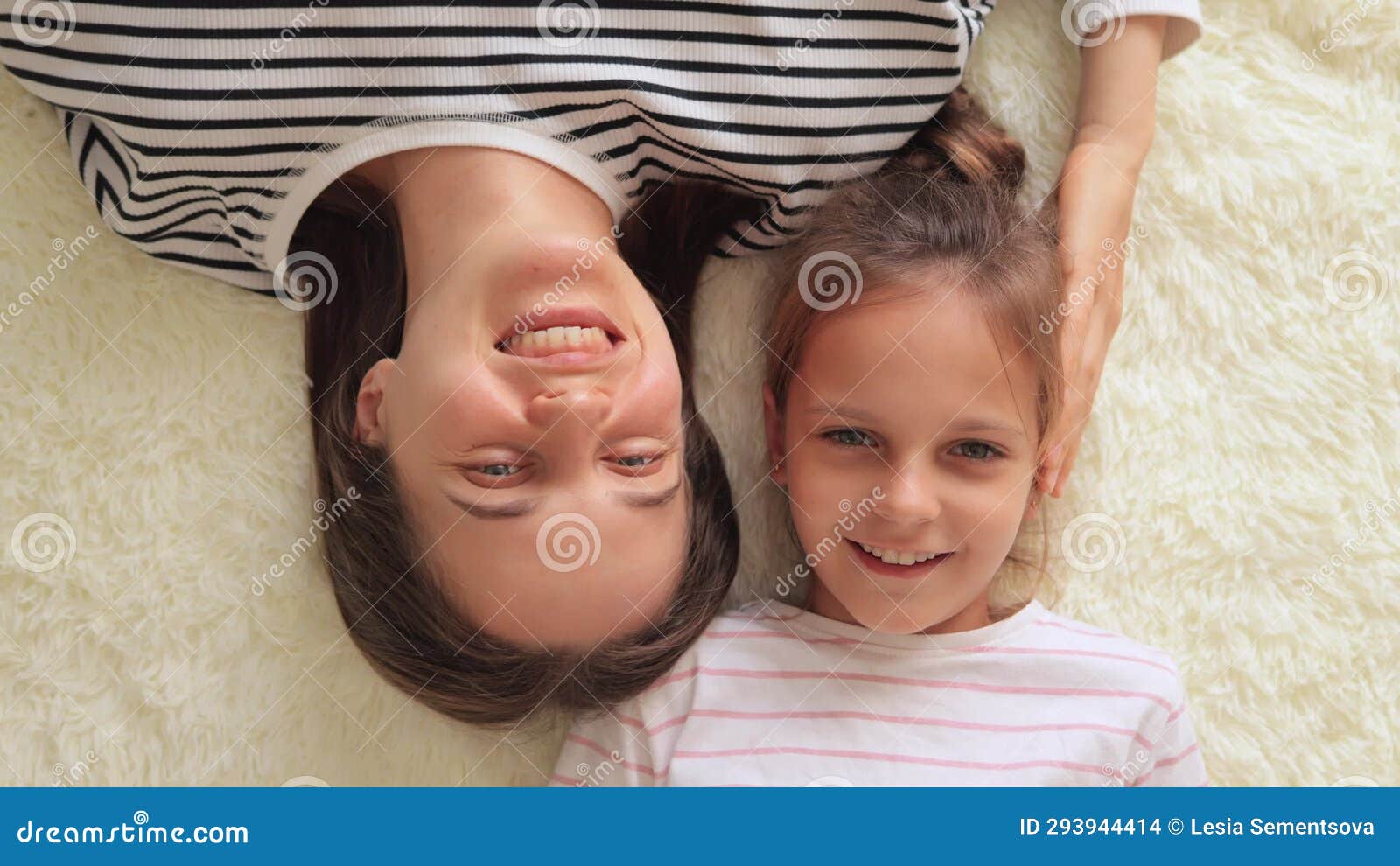 Top View Of Beautiful Young Mother And Her Daughter Looking At Camera