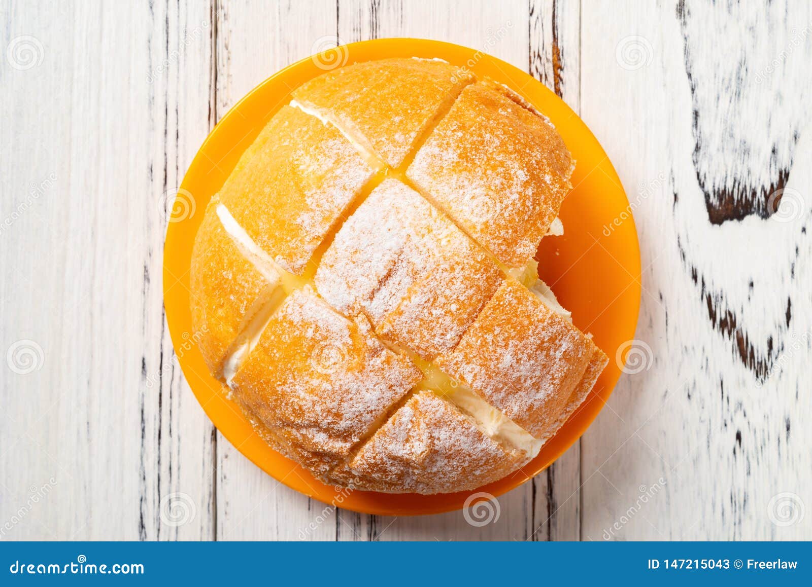 Bread with Cream Inside with a Bite on Wood Table Stock Image - Image ...