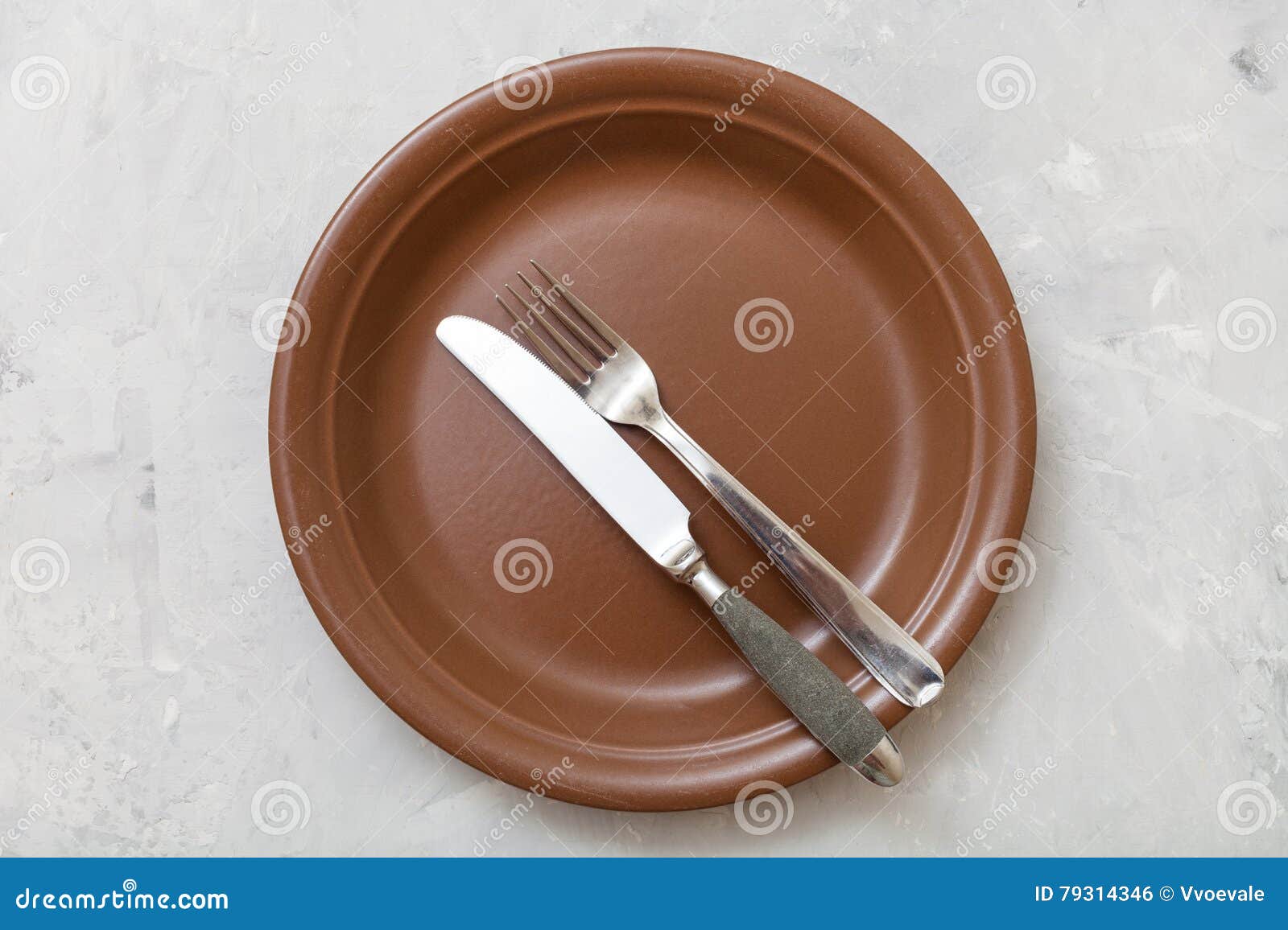 Top View of Brown Plate with Flatware on Concrete Stock Photo - Image ...
