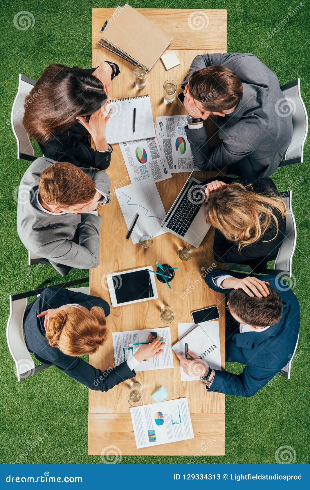 Top View of Business Partners Having Discussion at Table with Documents ...