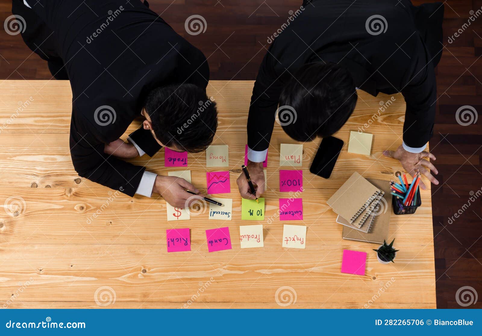 Business Team Gather on Table, Brainstorming and Writing Creative Idea ...