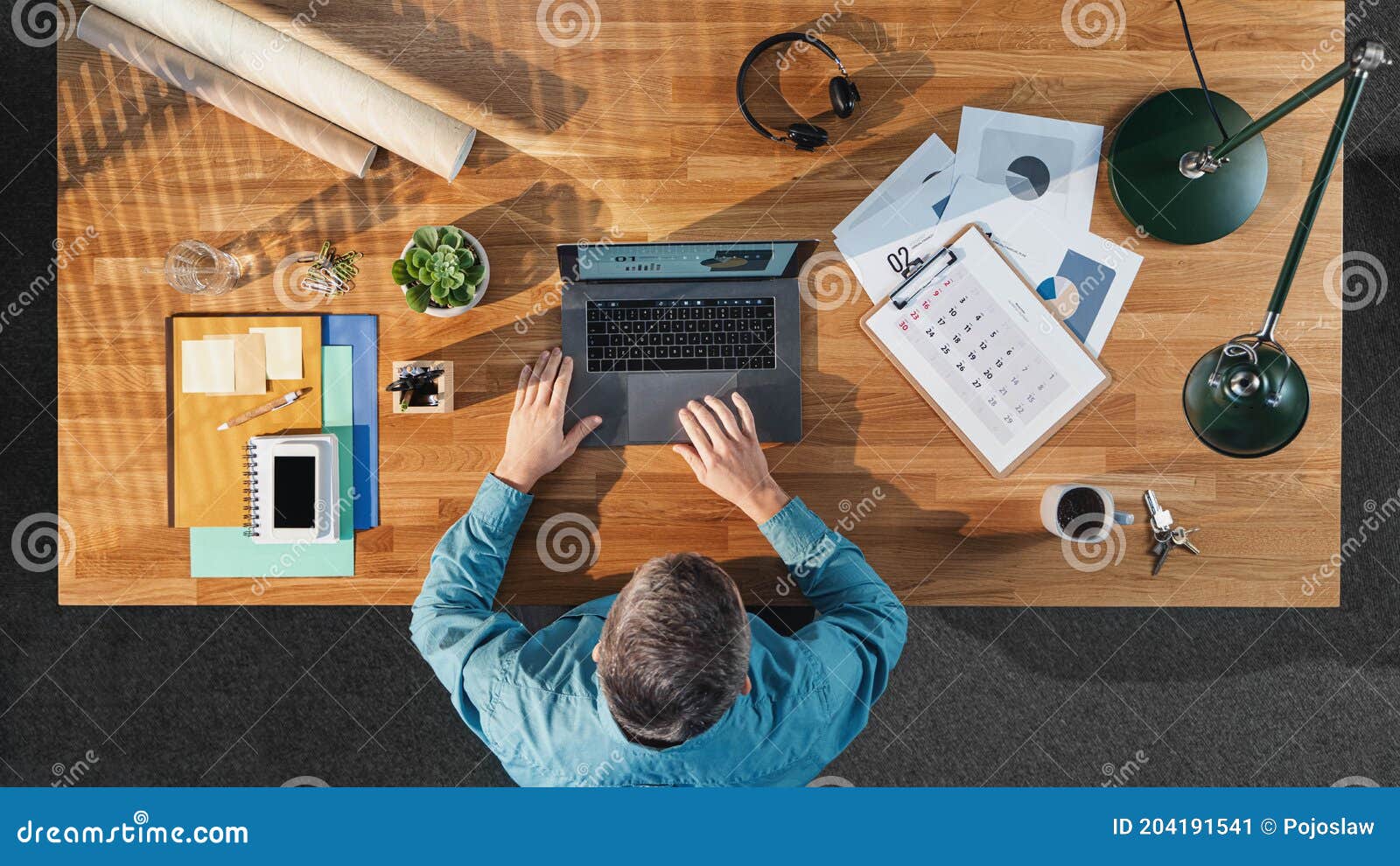 Top View of Businessman Working on Computer at Desk with Paperwork in ...