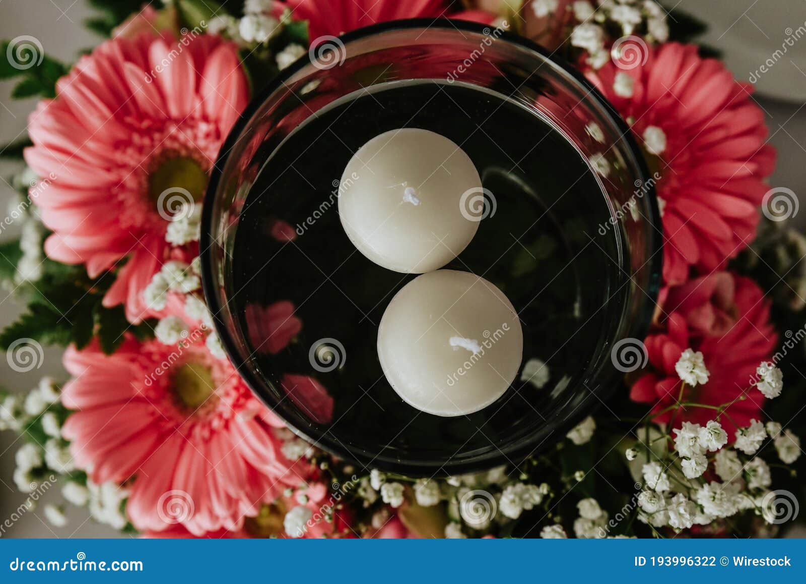 Top View of Candles Inside a Glass Container with Flowers Around it ...