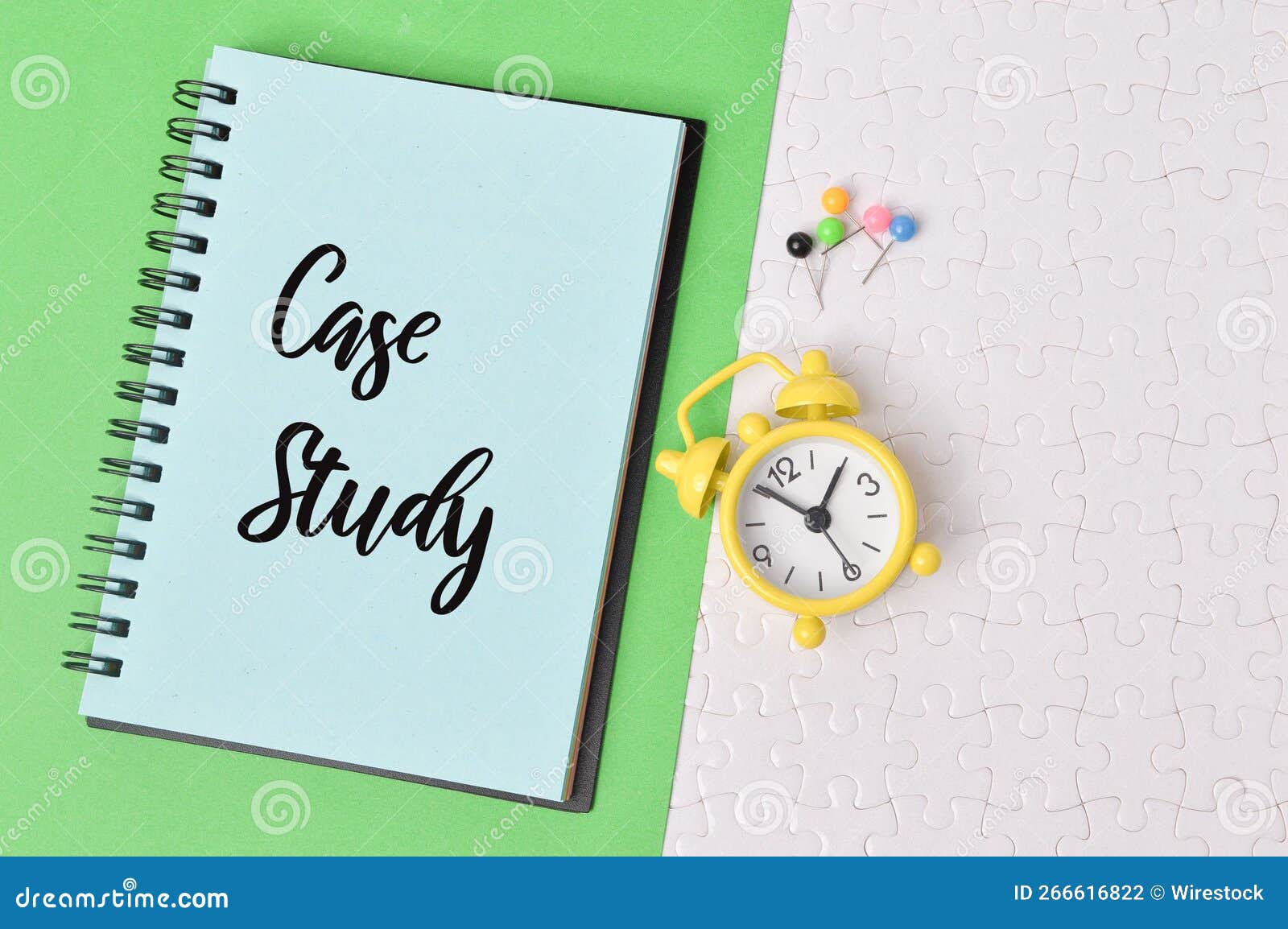 Top View of Clock and Notebook with "CASE STUDY" Text on a White Puzzle ...