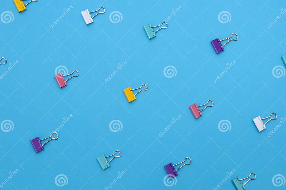 Top View of Colored Binder Clips on a Blue Paper Background, Selective ...
