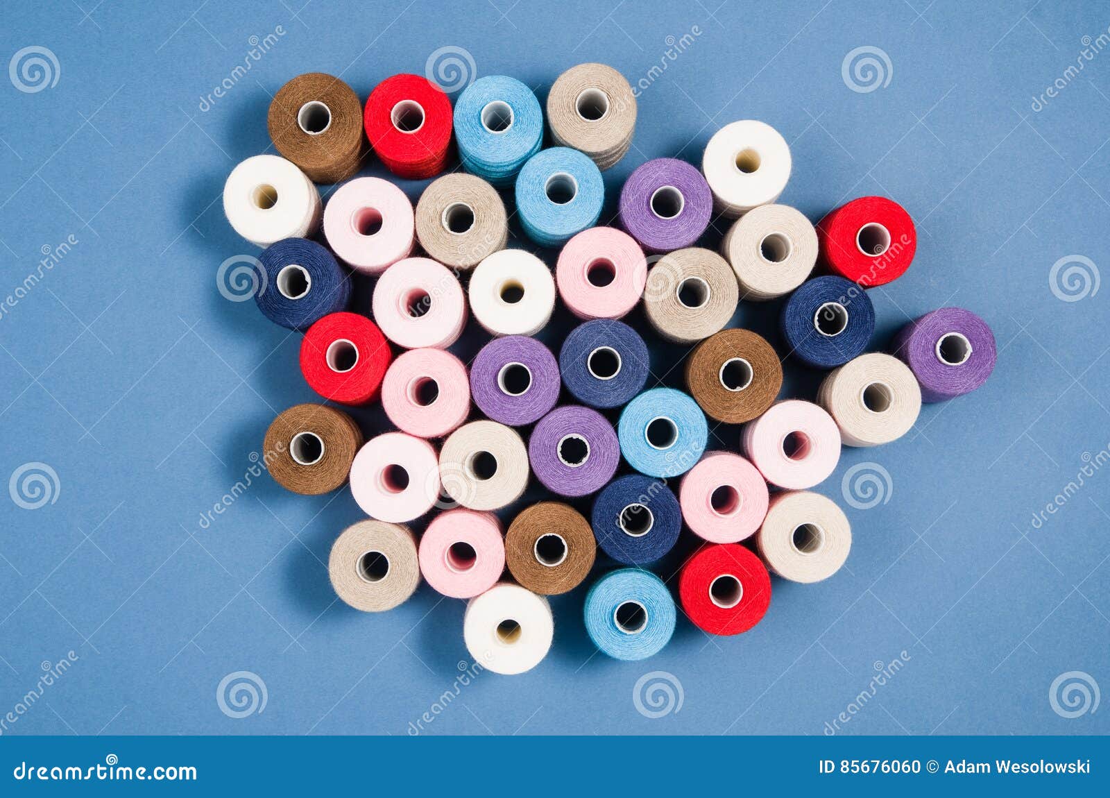Top View of Colorful Thread Spools Over Blue Background Stock Photo ...