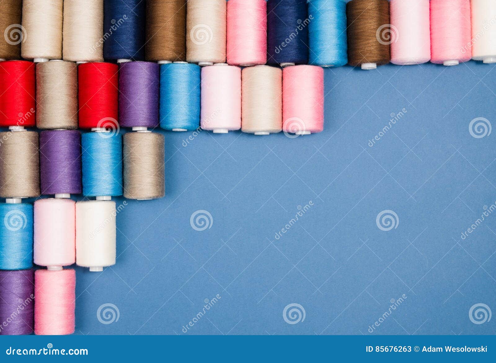 Top View of Colorful Thread Spools Over Blue Background Stock Image ...