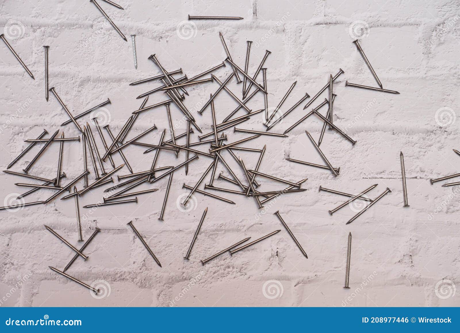 Top View of Concrete Nails on a White Brick Wall Surface Stock Photo ...