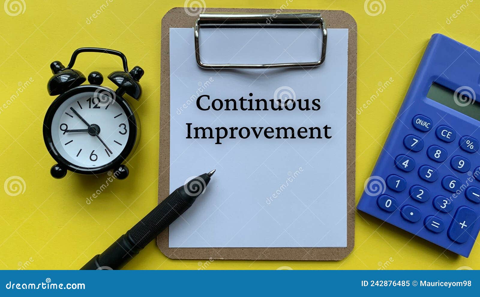 Top View of Continuous Improvement Text on Notepad with Yellow ...