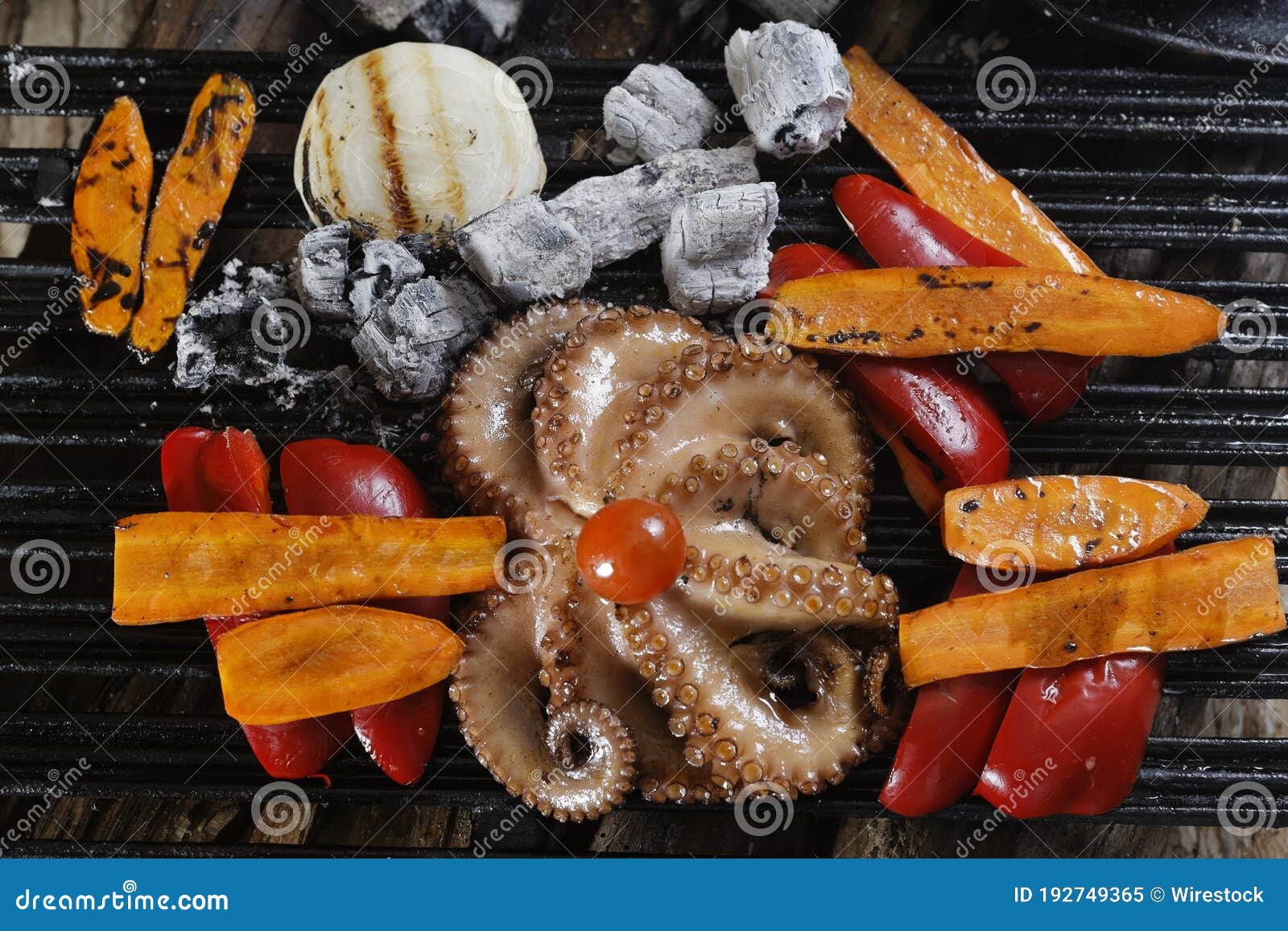 Top View of Cooked Octopus, Roasted Carrots, Peppers and Coal on a ...