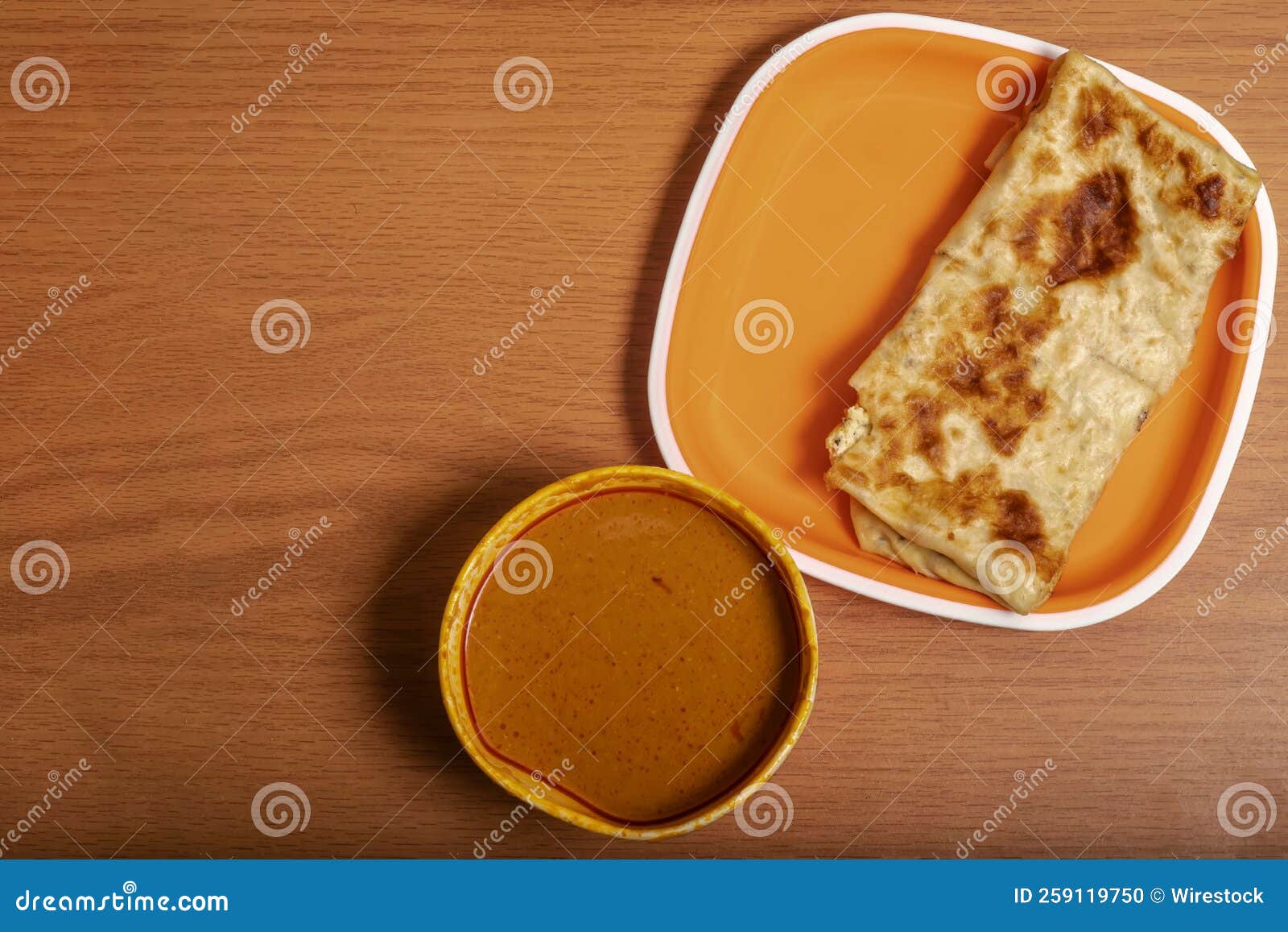 Top View of Egg Roti on a Plate with Another Small Plate on the Table ...