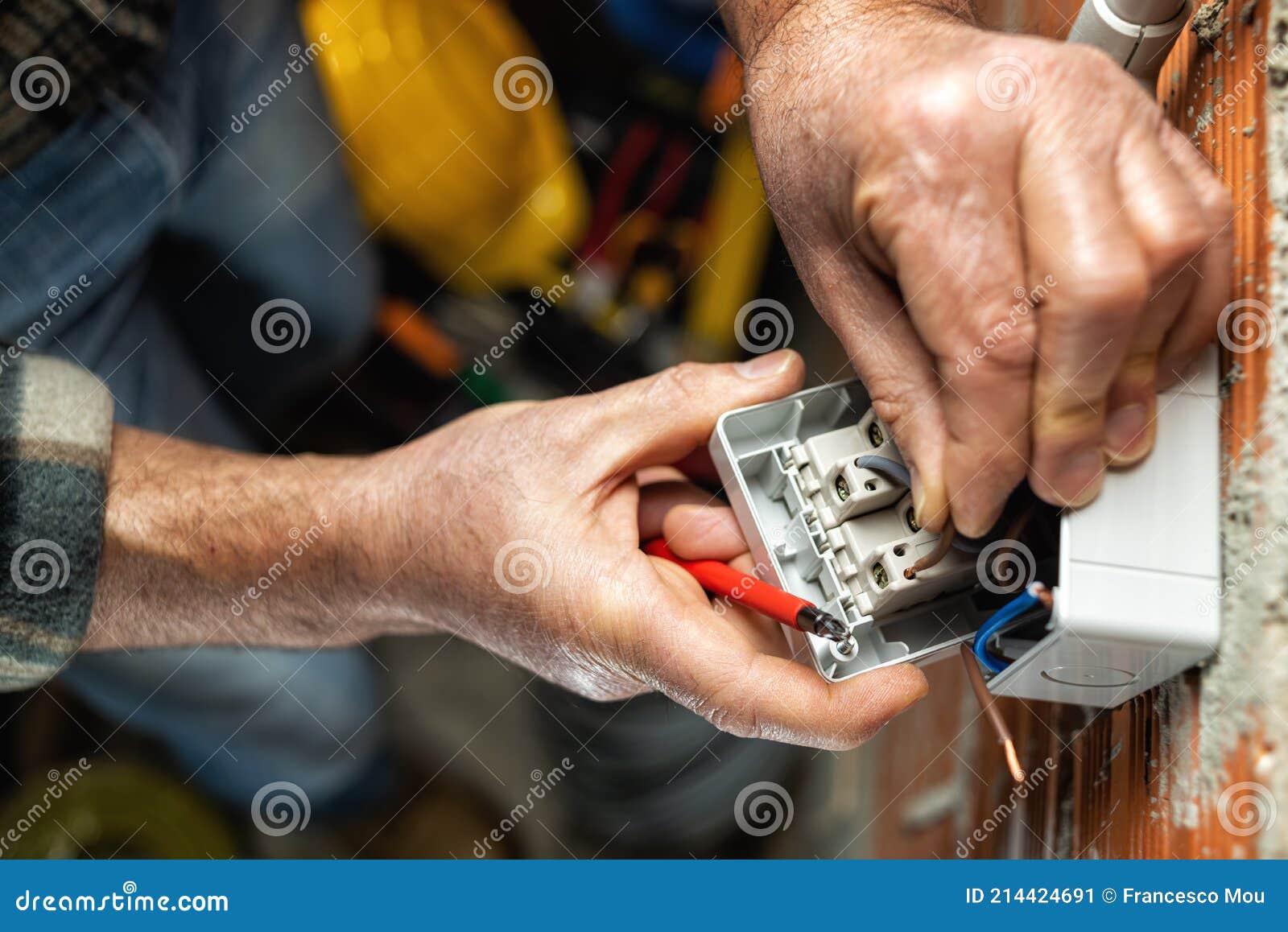 Electrician at Work on a Residential Electrical System. Electricity ...