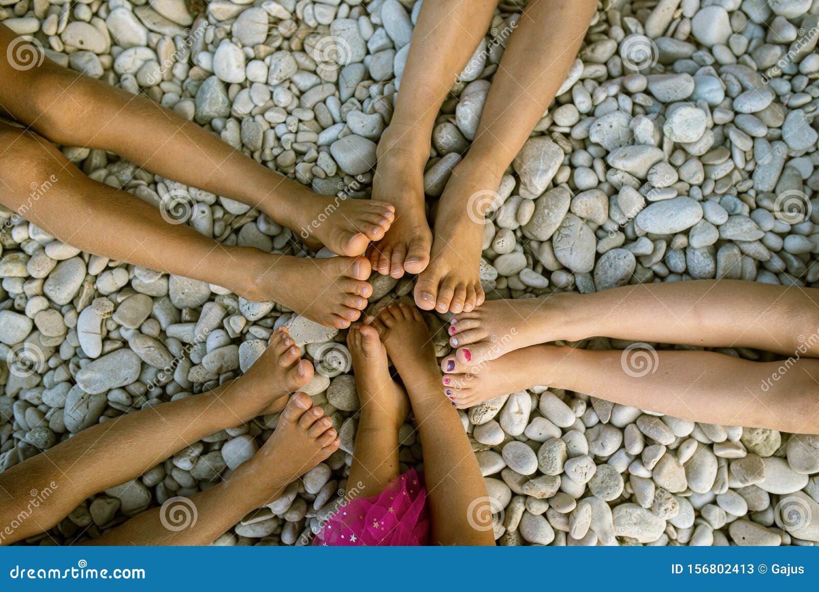 Kids feet on pebble beach stock image. Image of little - 156802413