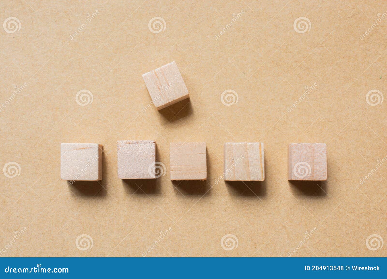 Top View of Five Cream Blocks on a Brown Surface with One Separate ...