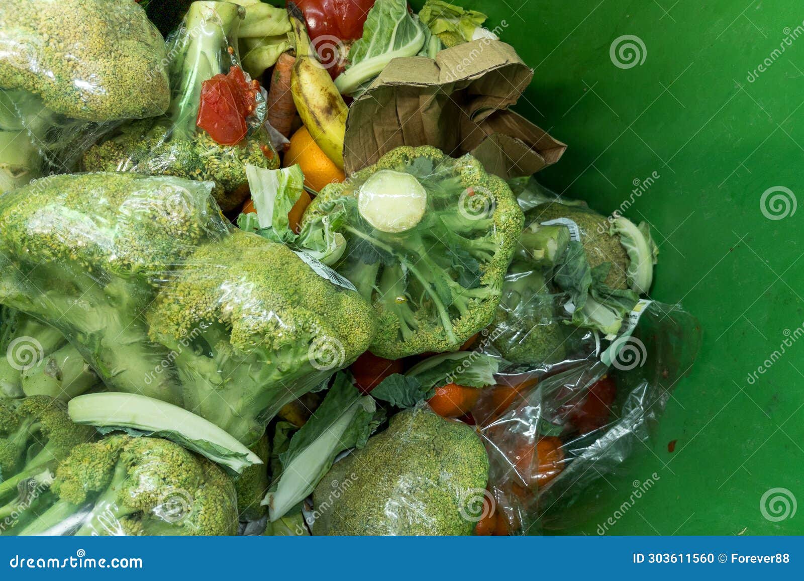 Top View of Garbage Can with of Rotting Broccoli in Plastic Packaging ...