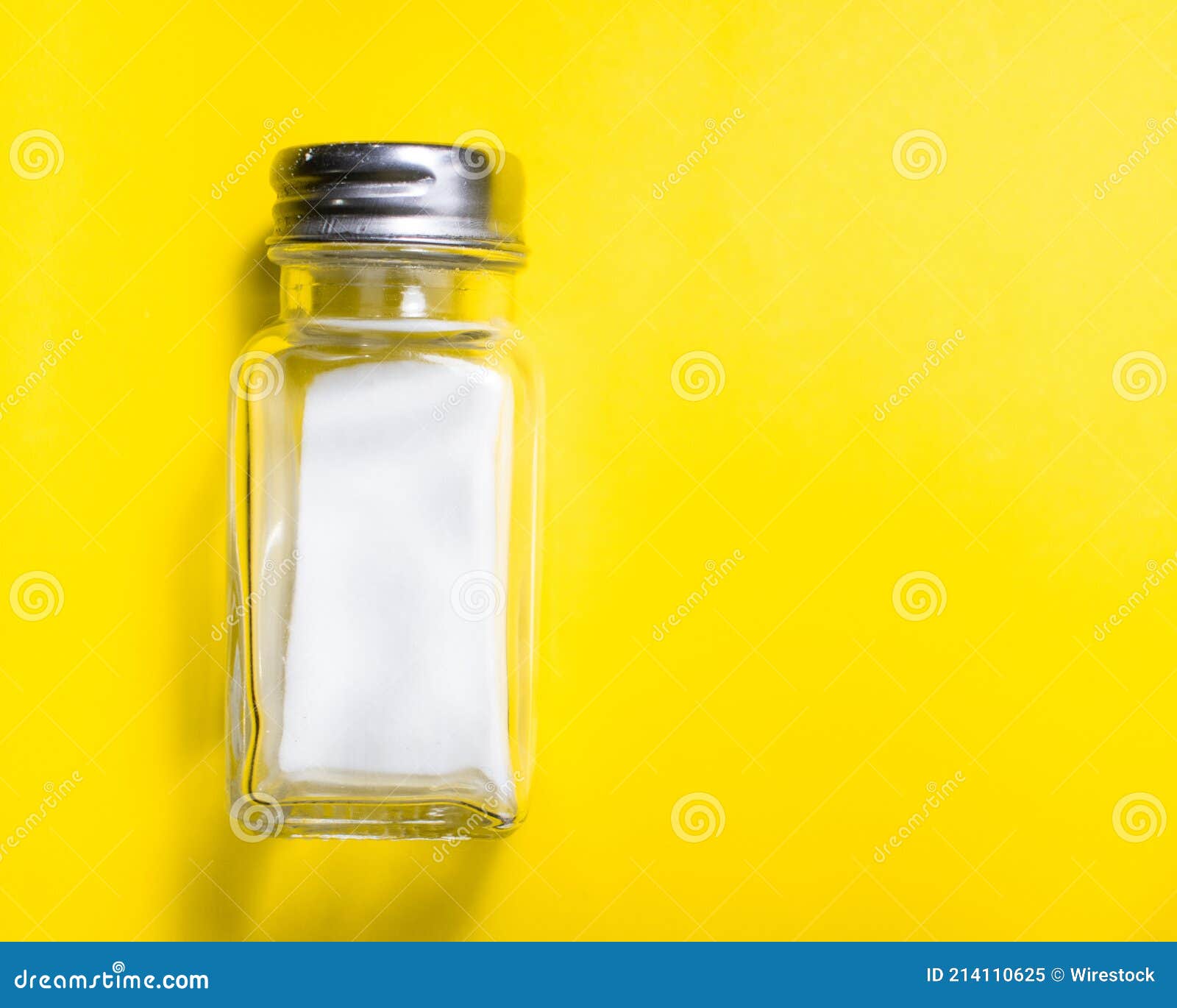 Top View of a Glass Salt Shaker Filled with Salt on a Yellow Surface ...