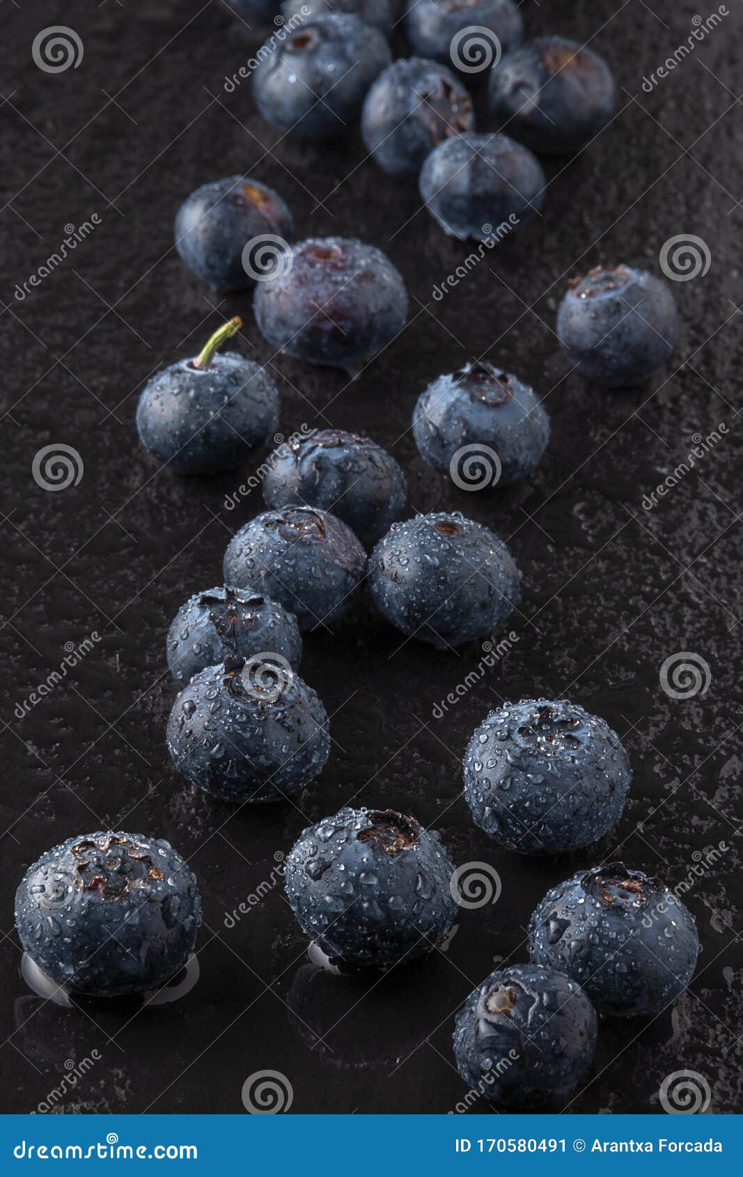 Top View of a Group of Wet Blueberries on Dark Slate in Vertical with ...