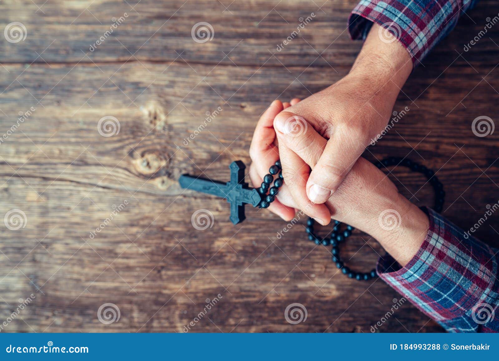 Top View of the Hands are Holding a Crucifix and Praying on a Rustic ...