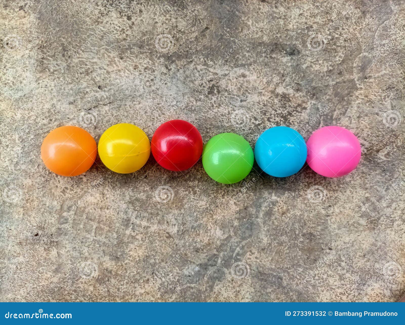 Top View Inline of Multicolor Plastic Balls on Cement Texture ...
