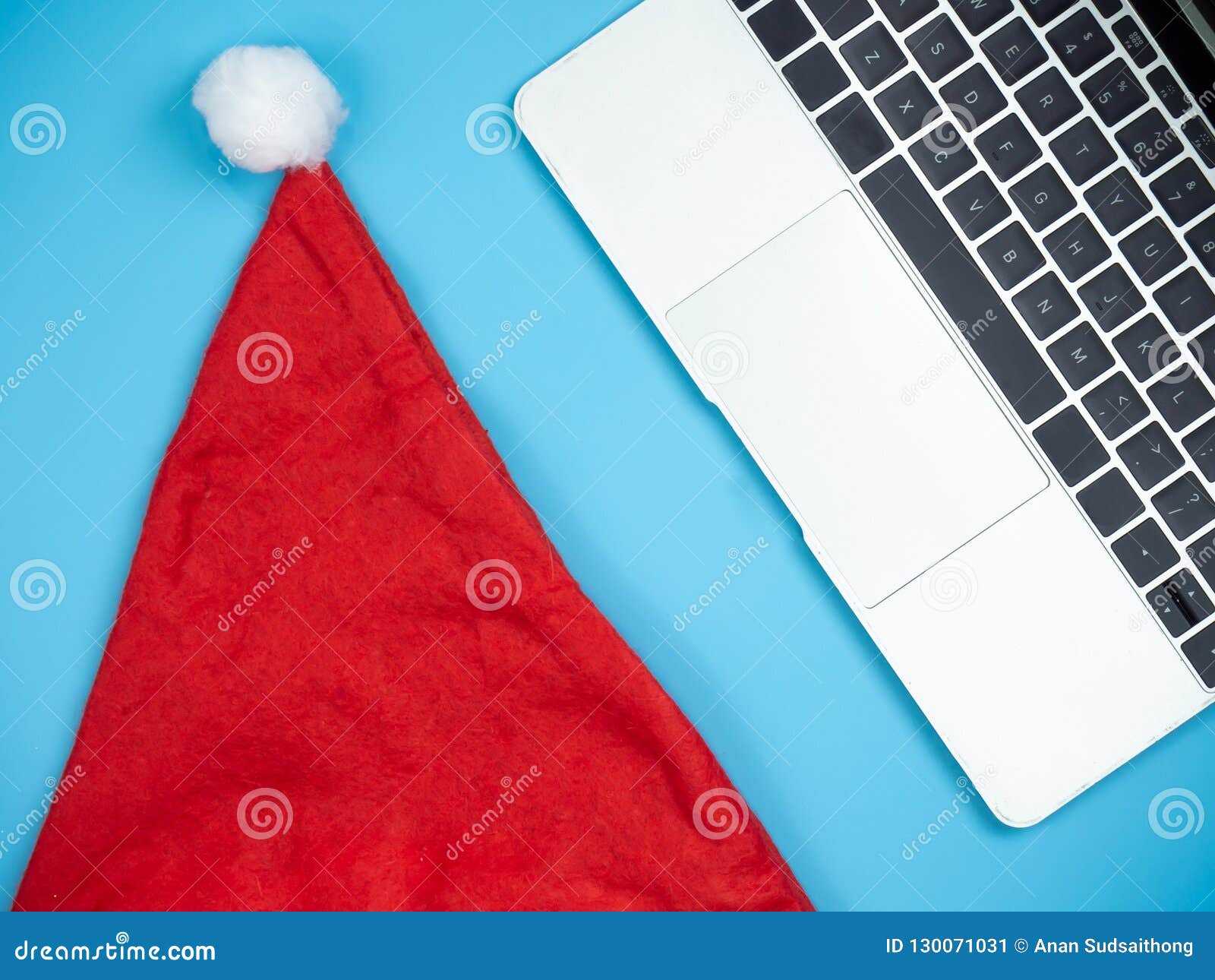 Top View of Laptop and Santa Hat on Blue Isolated Background. Stock ...