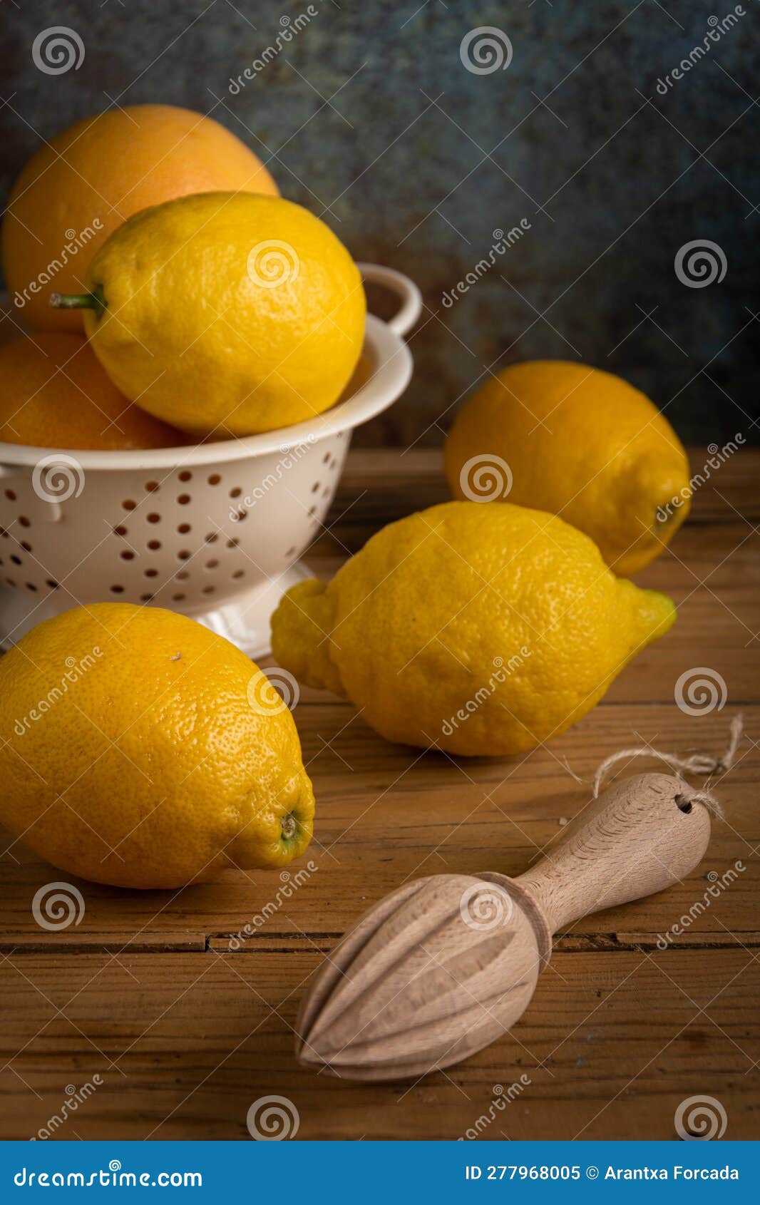 Top View of Lemons in Drainer on Rustic Table with Wooden Squeezer ...