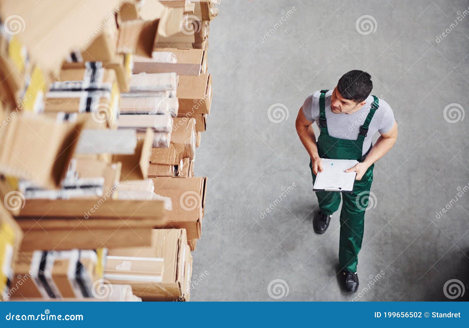 Top View of Male Worker in Warehouse with Notepad in Hands Stock Photo ...