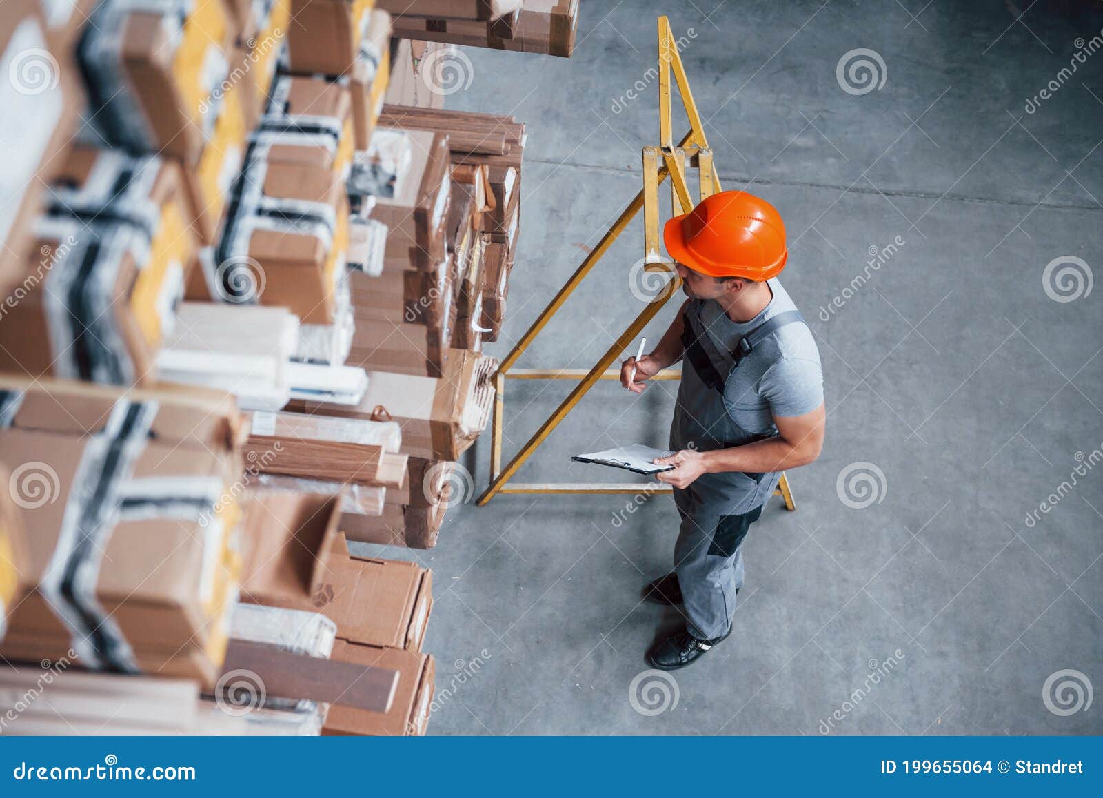 Top View of Male Worker in Warehouse with Notepad in Hands Stock Photo ...