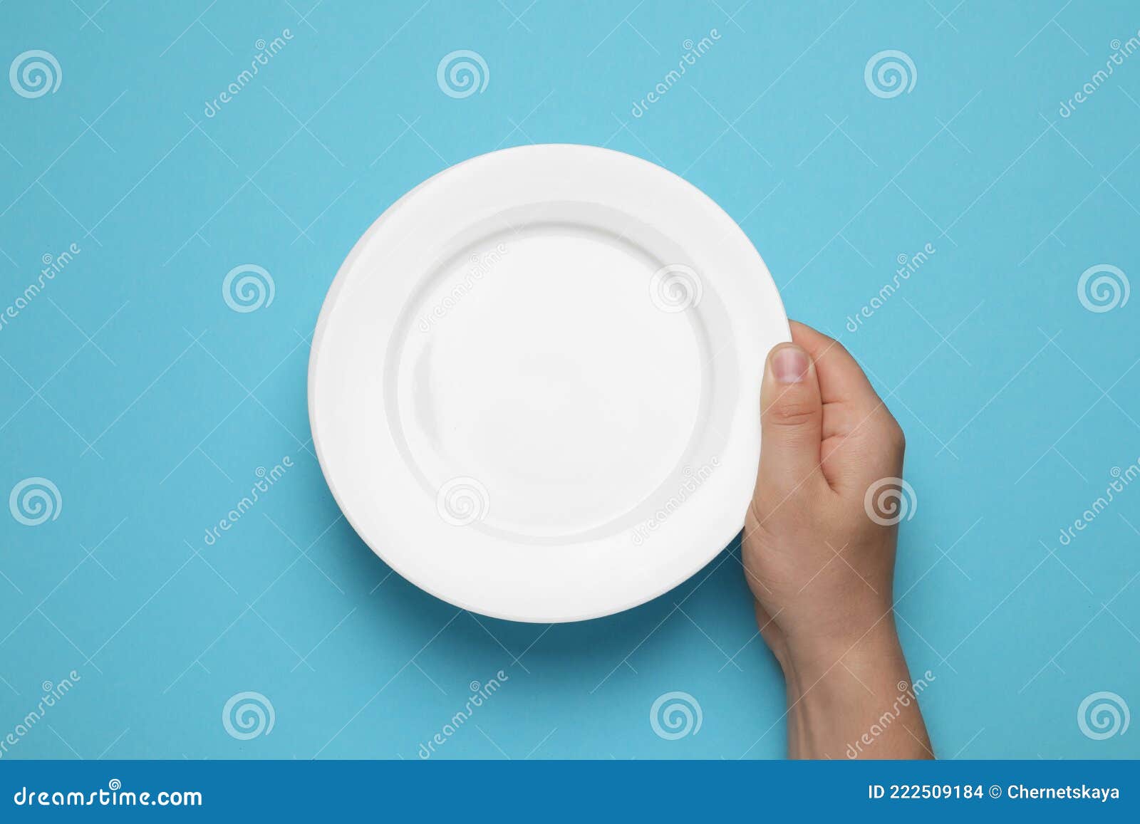 Top View of Man Holding Empty Plate on Blue Background, Closeup Stock ...
