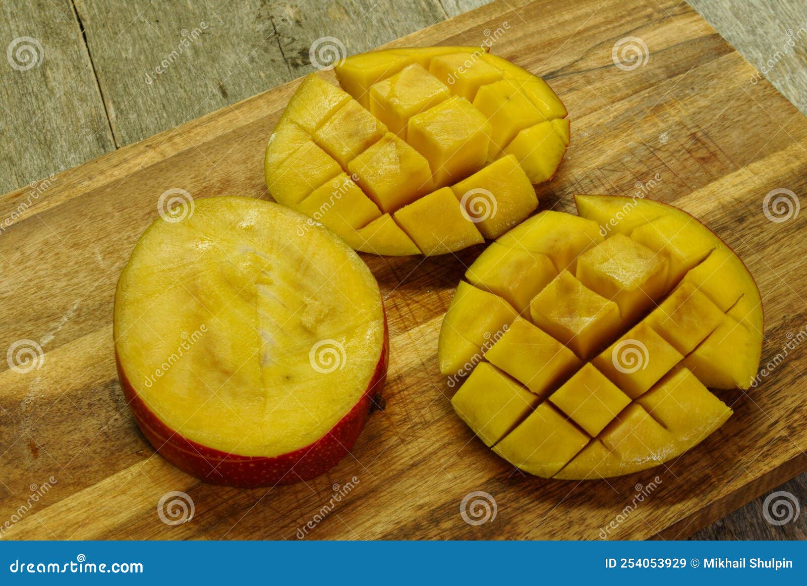 Top View of a Mango Fruit Cut into Three Parts Lying on a Wooden ...