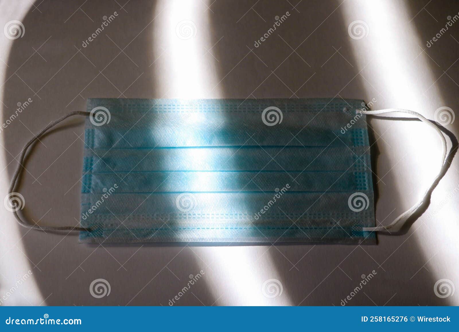 Top View of a Medical Disposable Mask with Sunlight Shadows Stock Photo ...