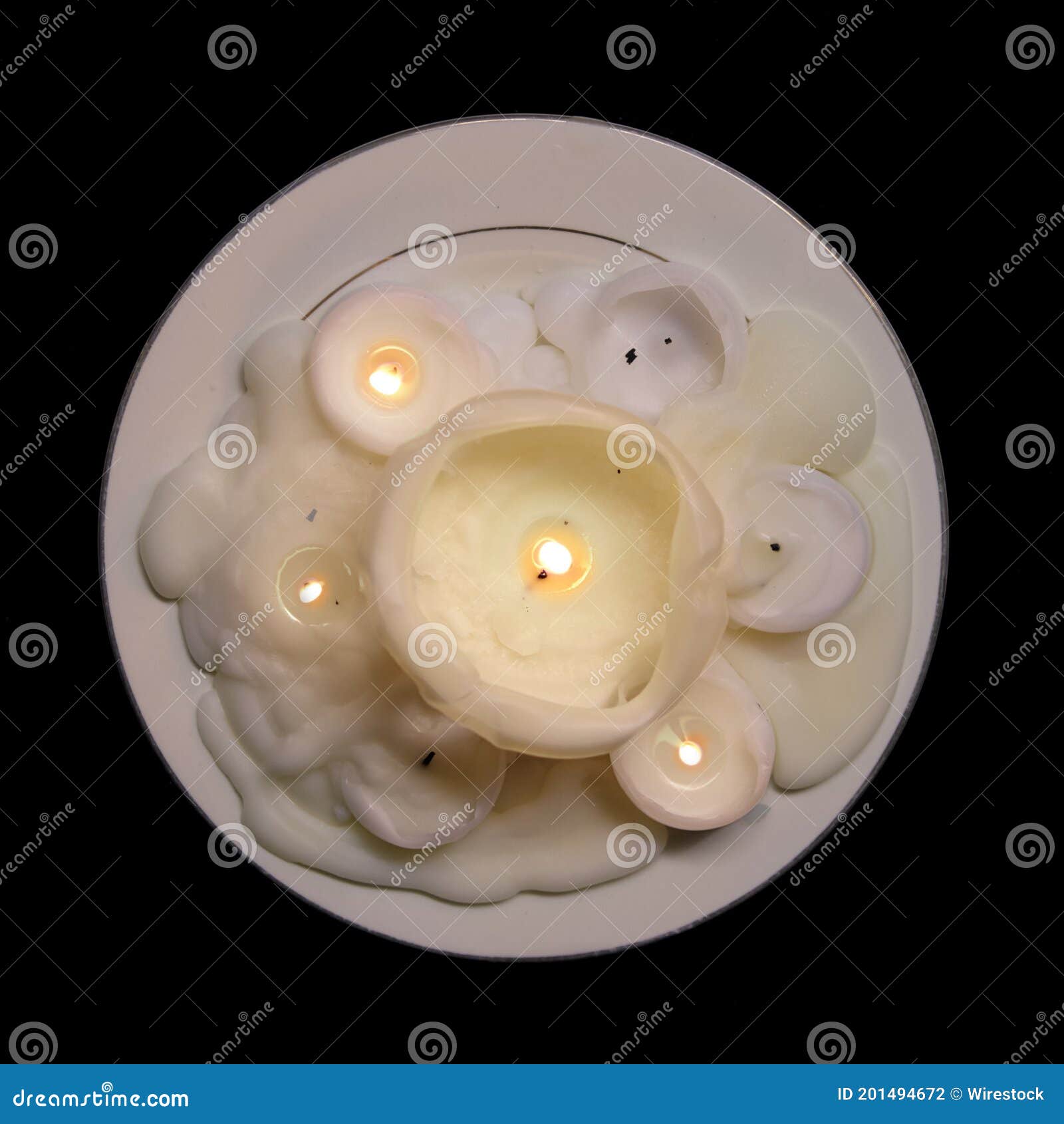 Top View of a Melted Candle Cluster on a Plate with Flames Stock Photo ...