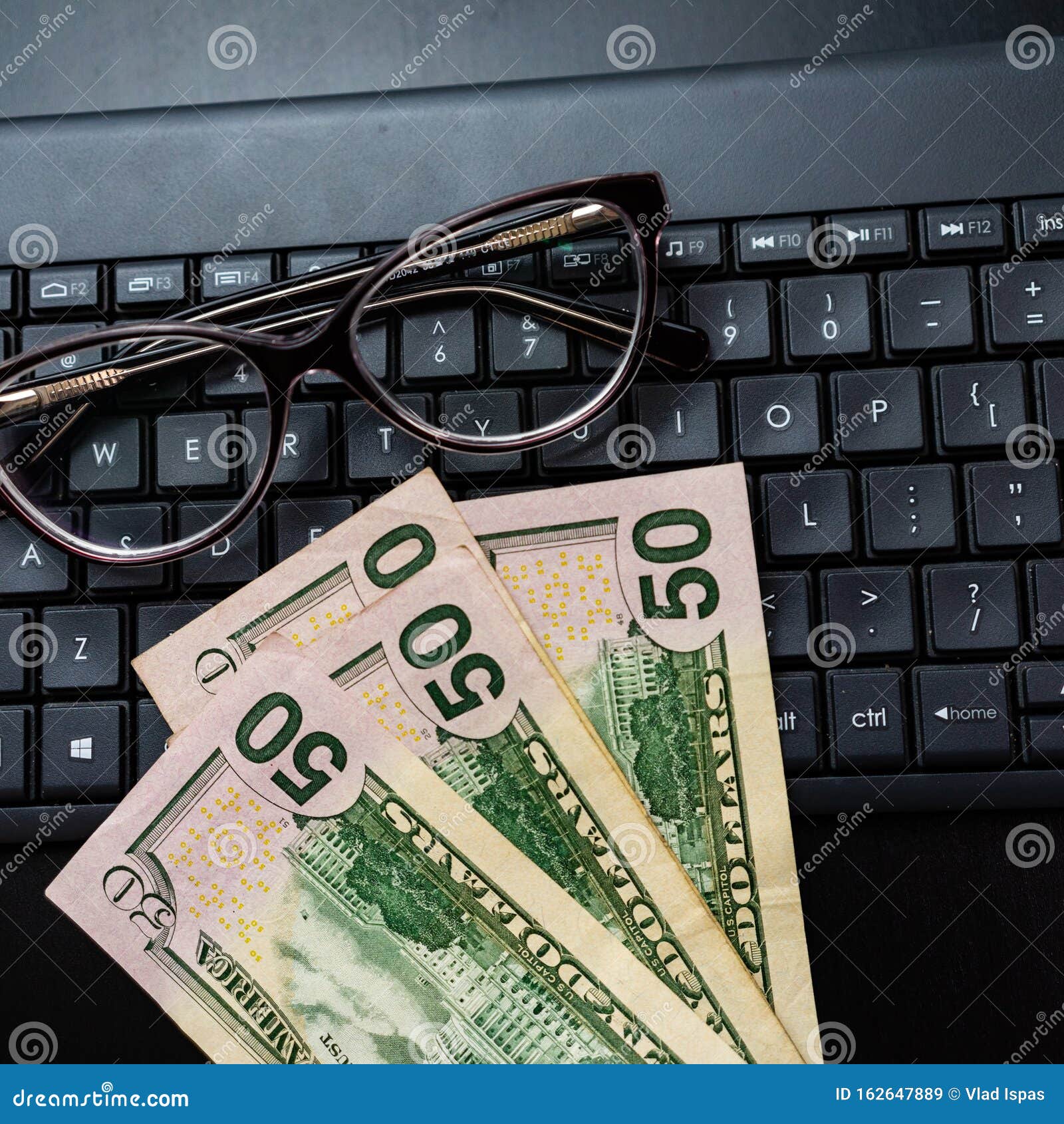 Top View of Money on Keyboard. Dollars Money and Glasses on Keyboard ...