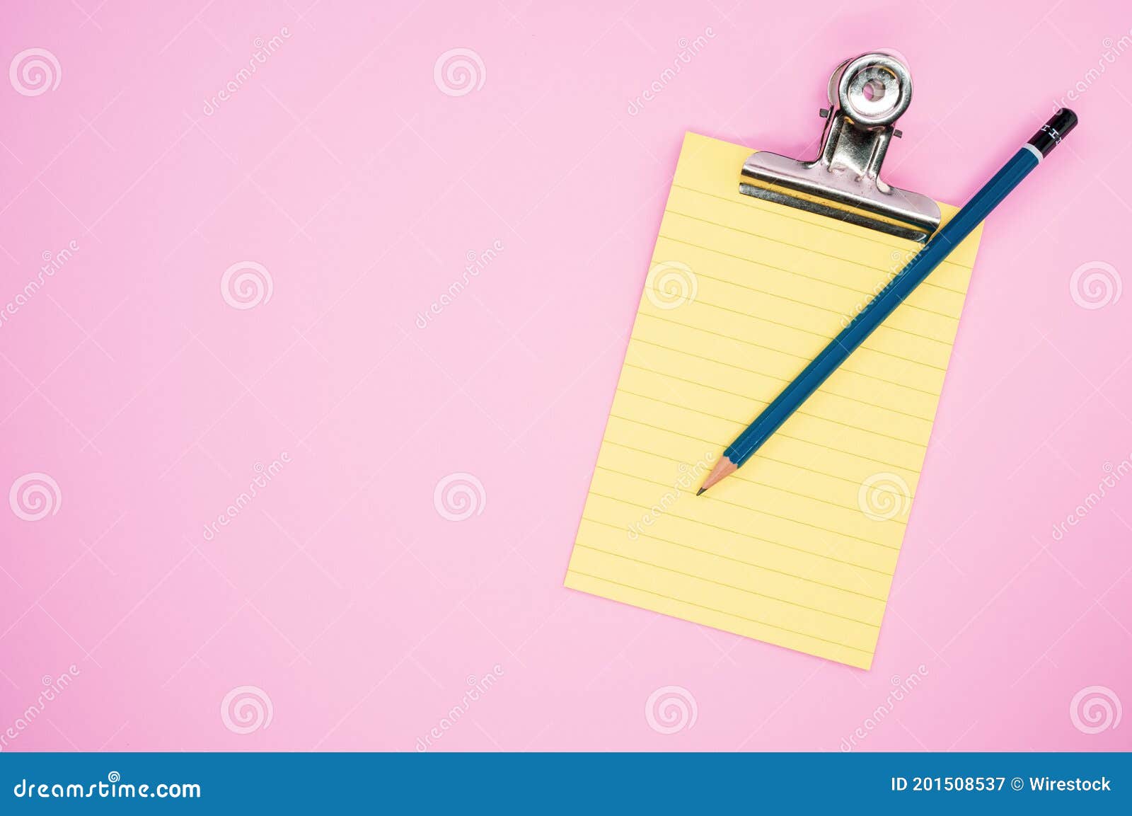 Top View of a Notepad with a Paper Clipper and a Pencil Isolated on a ...