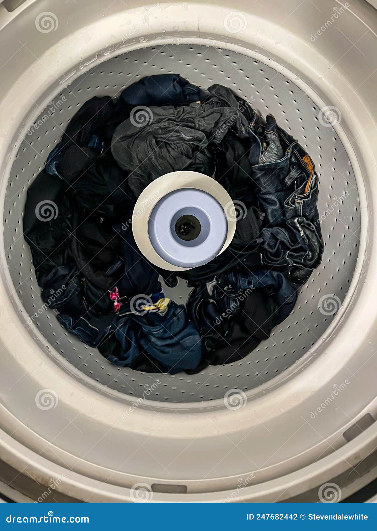 Top View of an Open Laundry Washing Machine with Dark Colored Cloths ...