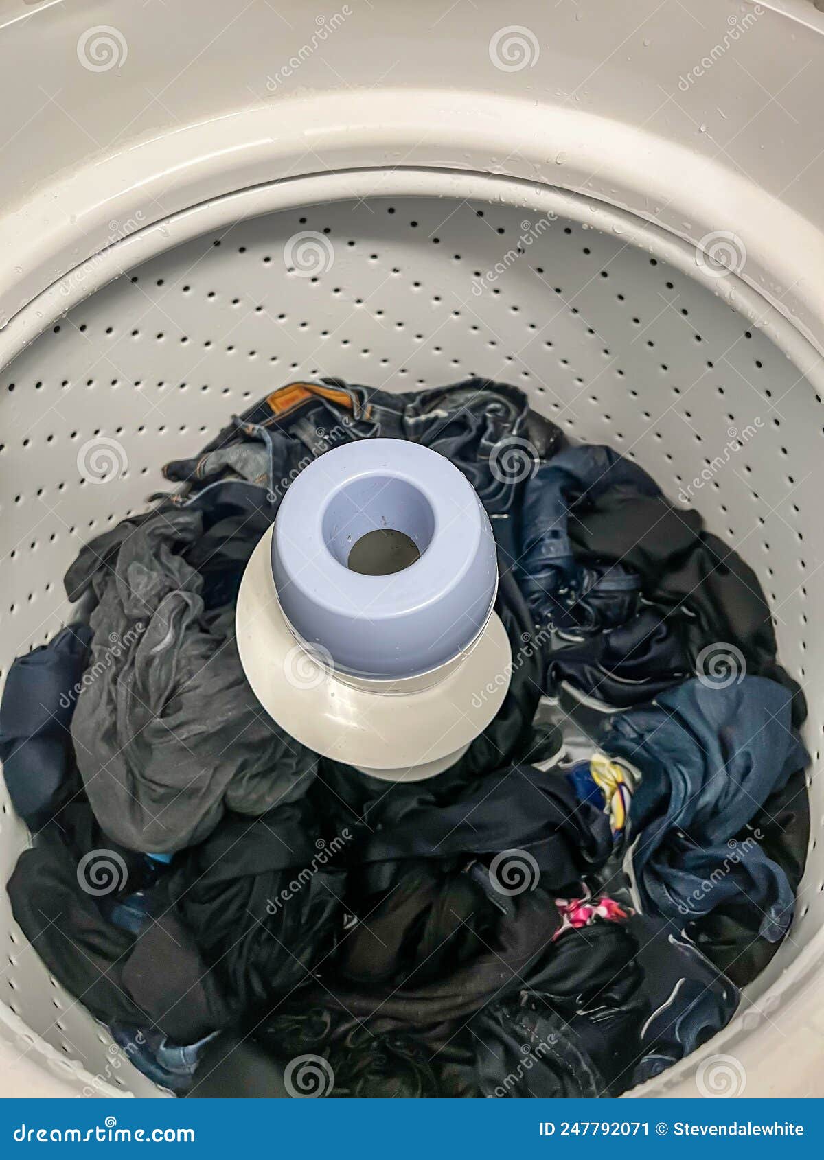 Top View of an Open Laundry Washing Machine with Dark Colored Cloths ...