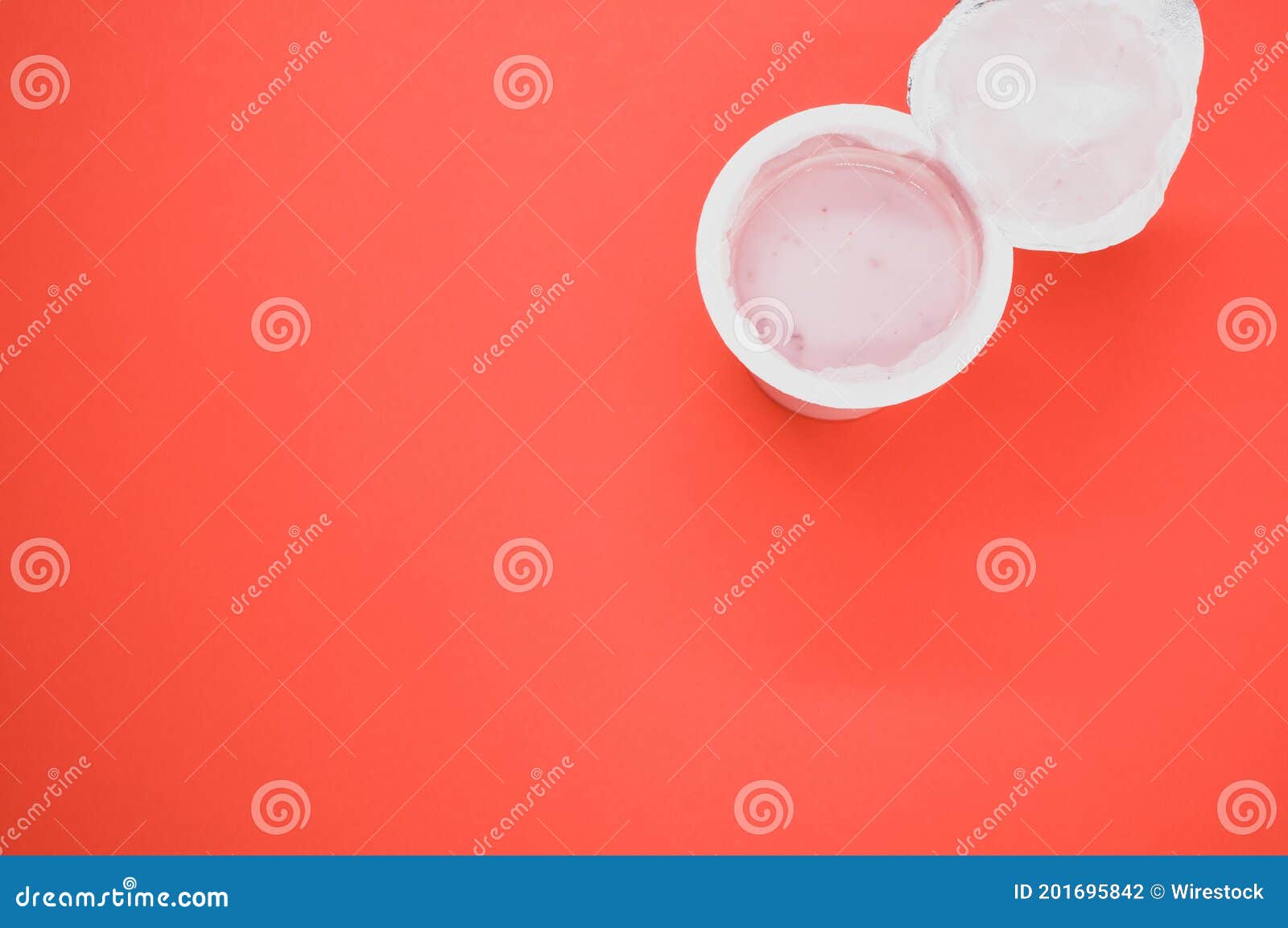 Top View of an Opened Plastic Container of Fruit Yogurt, on a Red ...