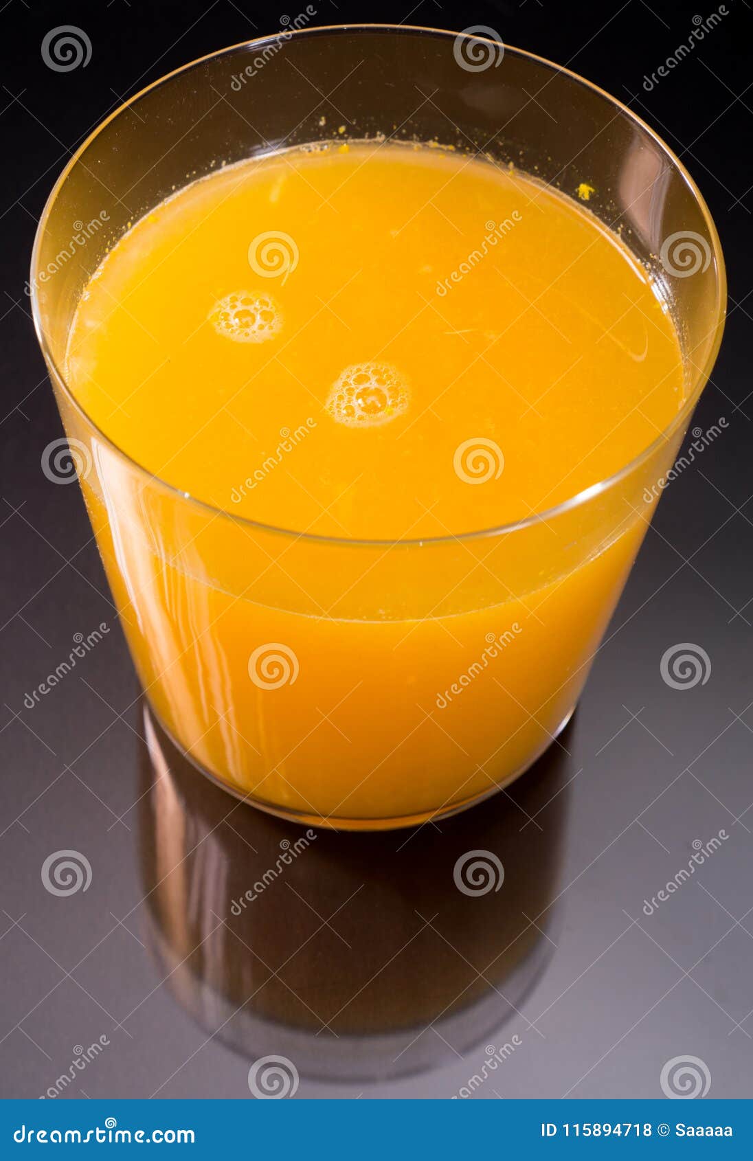 Top View of Orange Juice Over Black and Glass Reflection Stock Photo ...