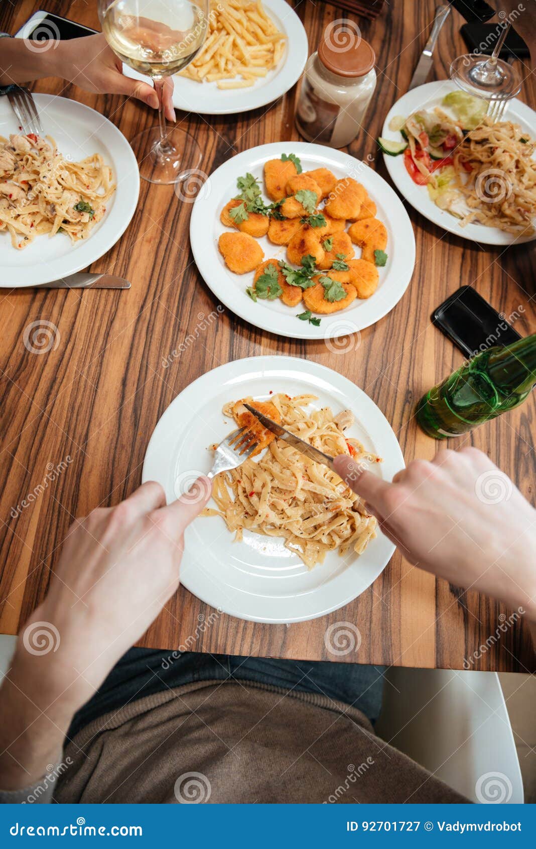 Top View of People Sitting at Table and Eating Pasta Stock Image ...