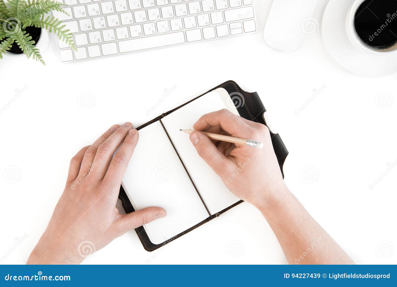 Top View of Person Writing in Diary at Workplace with Computer Keyboard ...