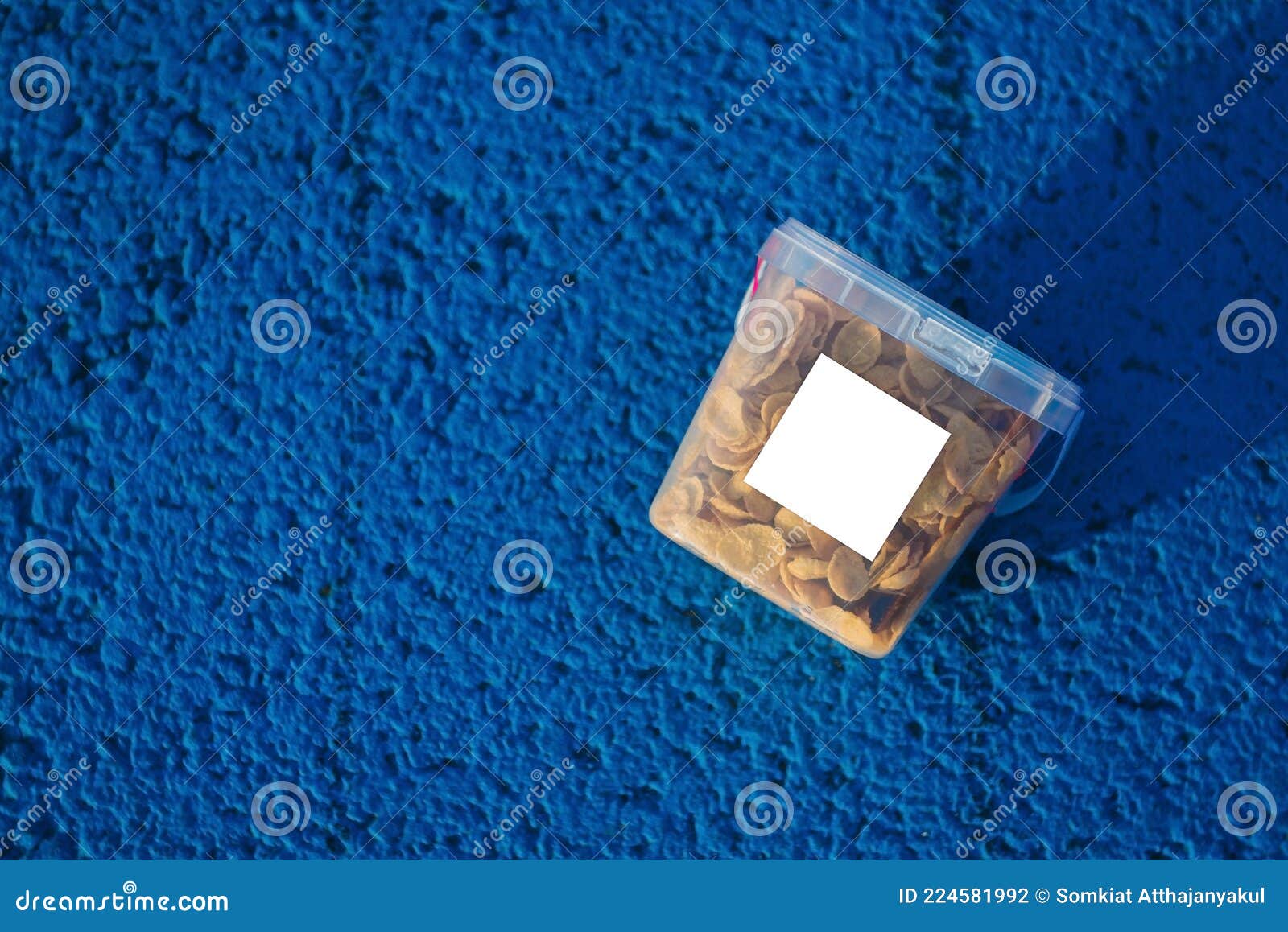 Plastic Box of Cornflakes on the Blue Cement. Stock Photo - Image of ...