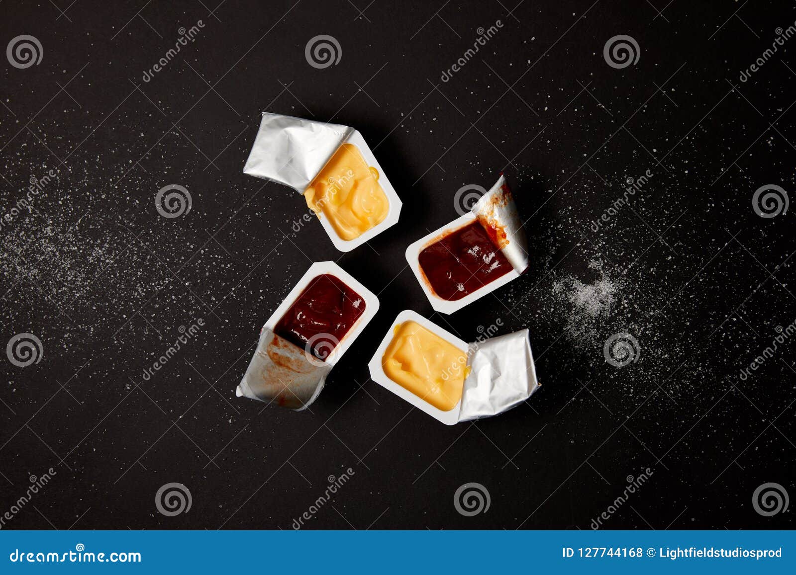 Top View of Plastic Containers with Sauces on Black Surface Spilled ...