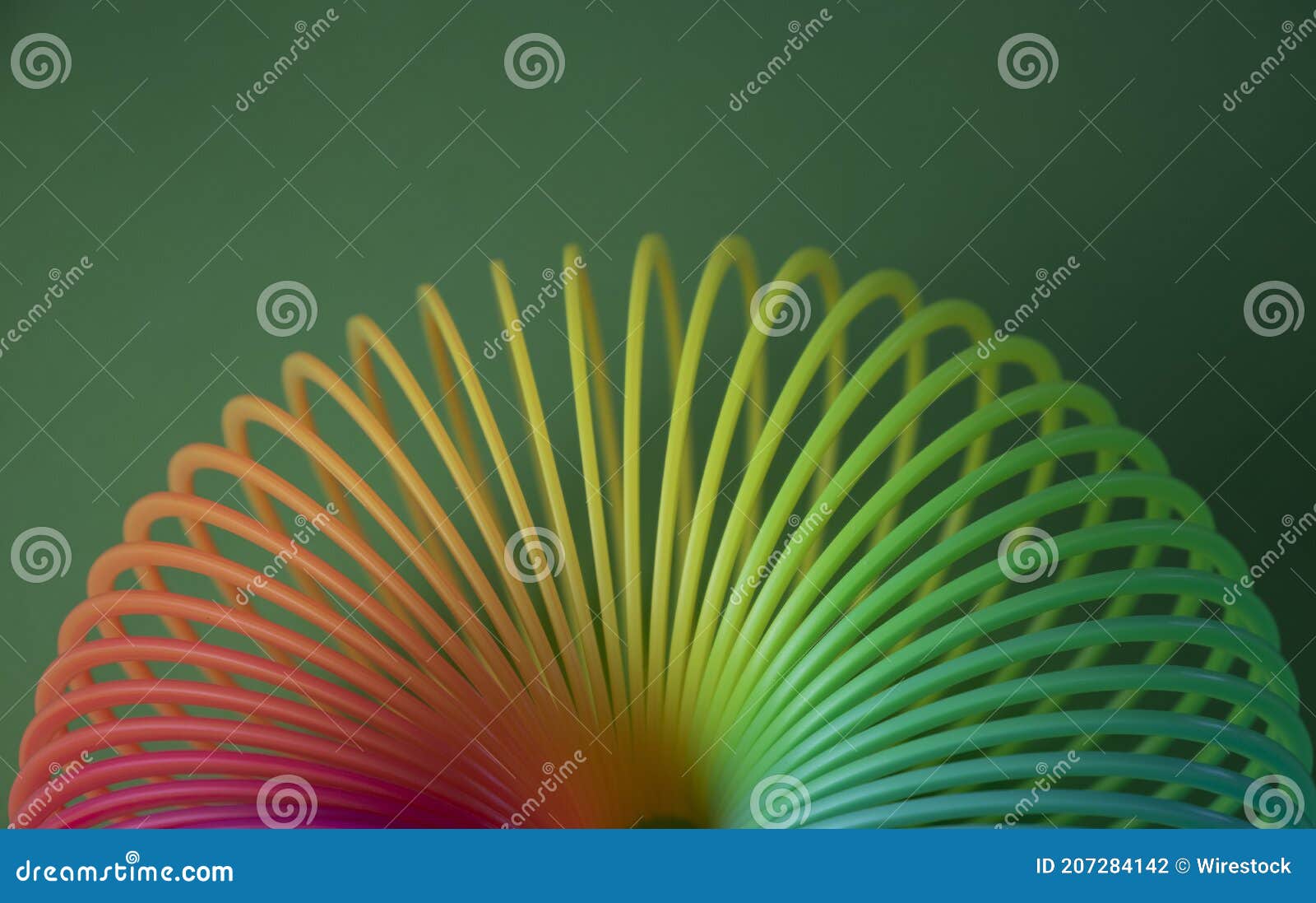 Top View of Plastic Rainbow Magic Spring Toy Isolated on Green ...